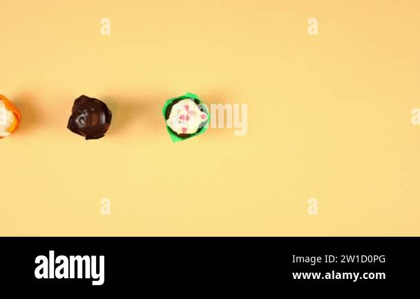 Stop motion animation of colorful muffin dancing on yellow background ...