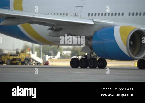 Working airplane engine of the standing aircraft on the airfield. 4K ...