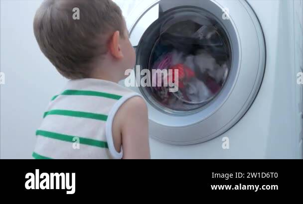 Cute Little Boy Looks Inside the Washing Machine. Cylinder Spinning ...