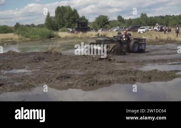 Festival of off-road lovers. SUVs drive the swamp. Cars skid in the mud ...