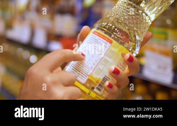 Woman Customer Reading Label On Sunflower Oil At Supermarket Stock ...