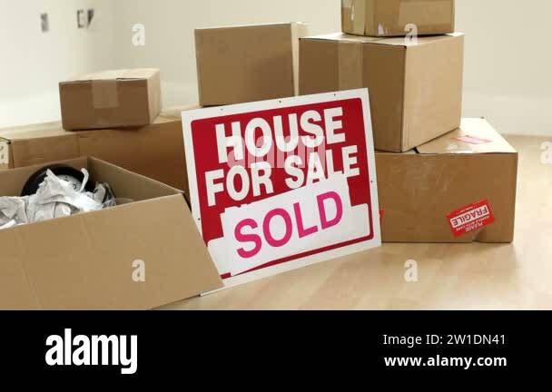 Boxes and sold sign Stock Video Footage - Alamy