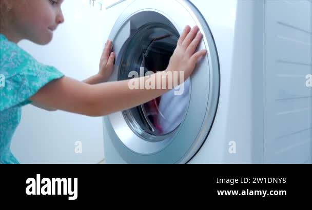Cute Child Looks Inside the Washing Machine. Cylinder Spinning Machine ...