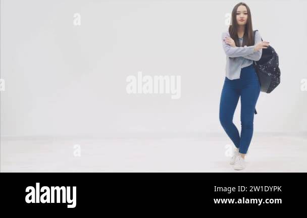 Full height asian, girl with long hair appearing on a white background ...
