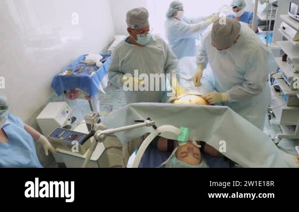 abdominal liposuction. surgery. the surgeon pumps out the fat through a ...