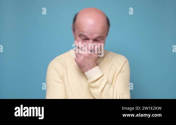 Senior man laughing and embarrassed giggle covering mouth with hands ...