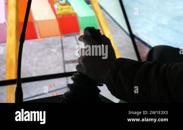 Vessel crane simulator with a sailor controlling the load movement in ...