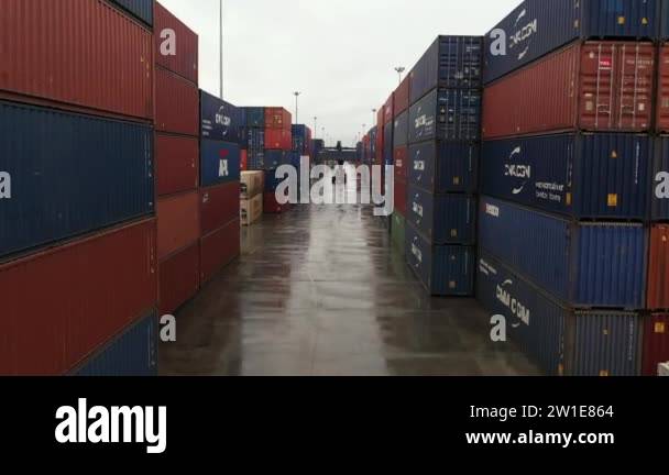 Camera movement between shipping containers at the cargo terminal. Work ...