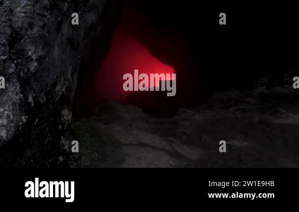 Man silhouette in an underground abandoned crypt with burning red ...