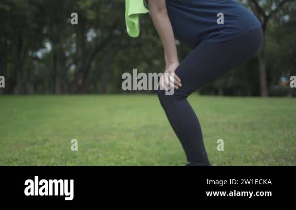 Active young woman doing knees muscle warm up exercise at the park ...