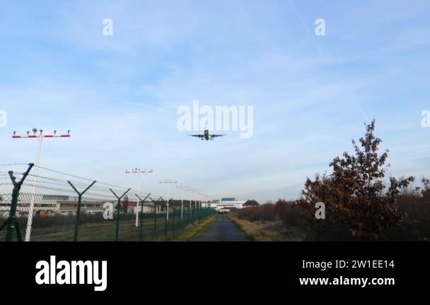 Landing approach of an airplane on runway Northwest at Frankfurt ...