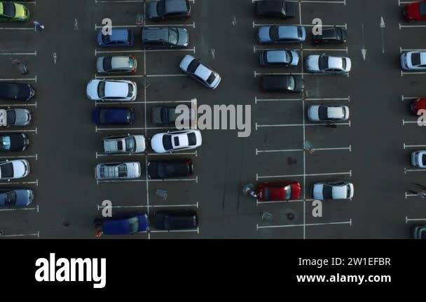 Drone footage cars parking at congested parking lots. people walking ...