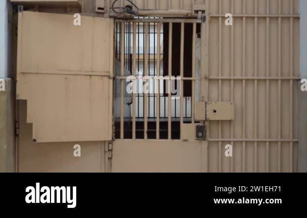 steel door with bars at the entrance to the prison corridor with prison ...
