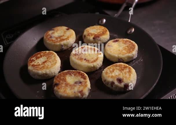 Cottage cheese cakes frying ion hot pan in restaurant kitchen.Delicious ...