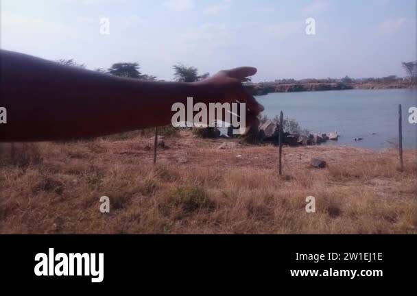 Man's finger pointing at the lake gesturing to point at something for ...