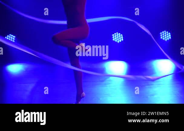 Rhythmic gymnastics. Flexible gymnast with tape creates beautiful hands ...