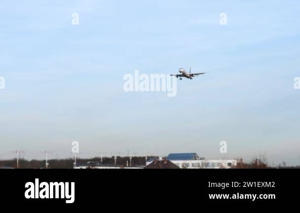 Landing approach of an airplane on runway Northwest at Frankfurt ...