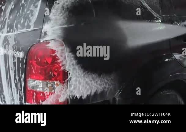 A man washes a black car. Slow Motion Video of a Car Washing Process on ...