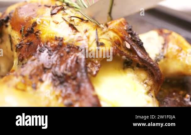 Close up of delicious whole roasted chicken with crispy crust. Action ...