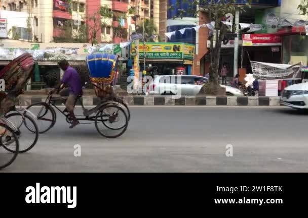 Unidentified people and street traffic at the Ring Road in the Adabor ...