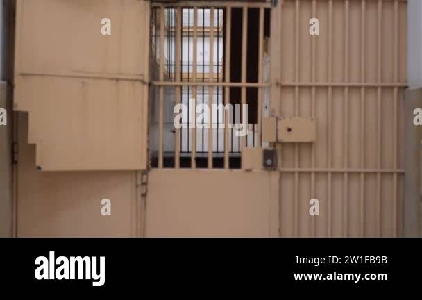steel door with bars at the entrance to the prison corridor with prison ...