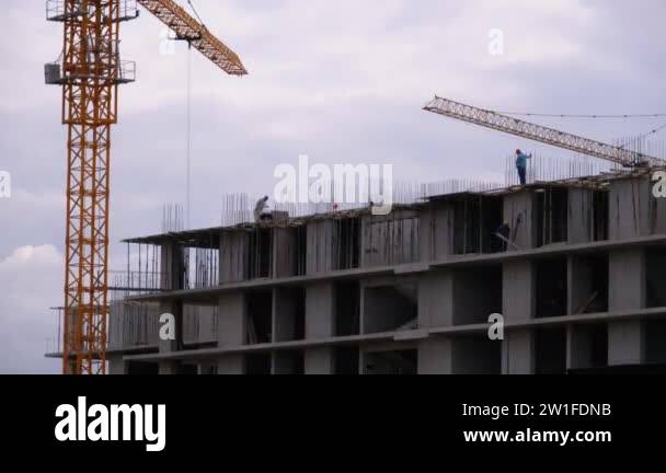 Builders on the Edge of a Skyscraper Under Construction. Workers at a ...