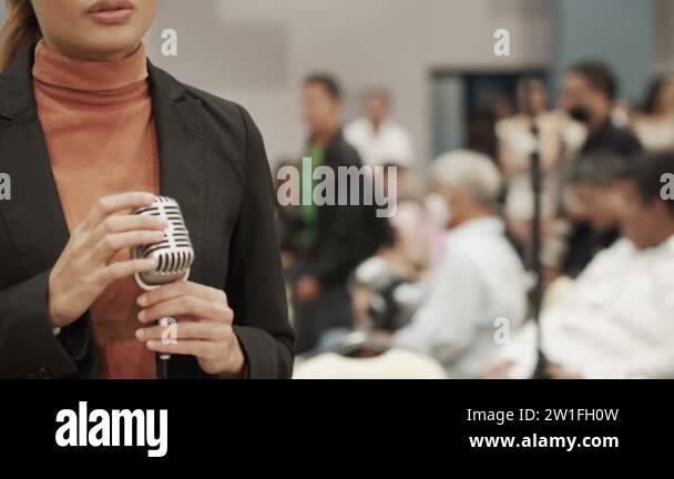 20s Asian Woman News Reporter hold microphone look at camera, wear ...