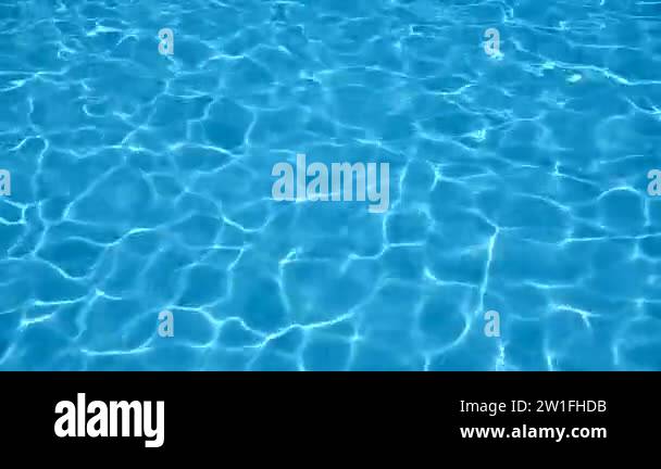 Lighting effects on rippling water in a swimming pool background ...