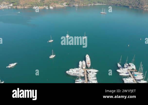 Marina and pier with yachts, seaside town on the beach, hotel and ...