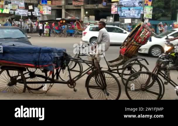 Unidentified people and street traffic at the Ring Road in the Adabor ...
