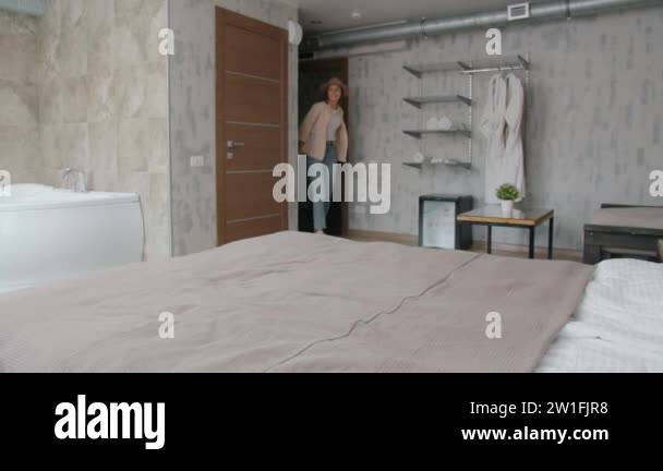 Girl And Guy With Suitcases Going Inside Hotel Room Then Lying In Bed 7499