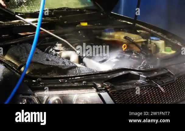 Self service car wash. Man washing his car at automobile washing ...