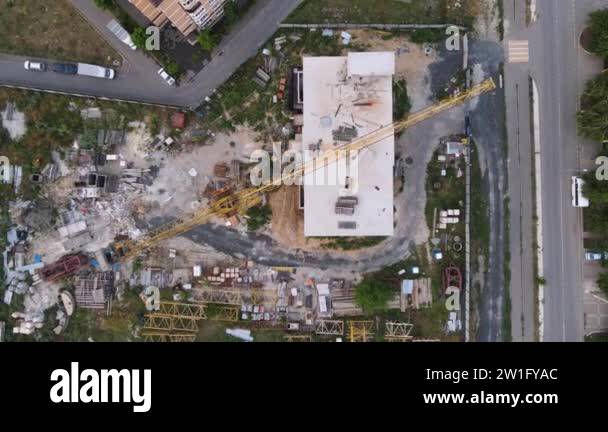 Construction site with crane, unfinished high-rise and storage of ...