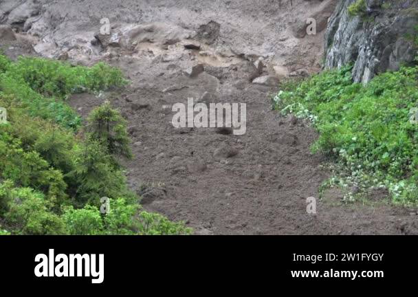 Muds of landslide flows down the valley. Stone rock and soil mixed with ...