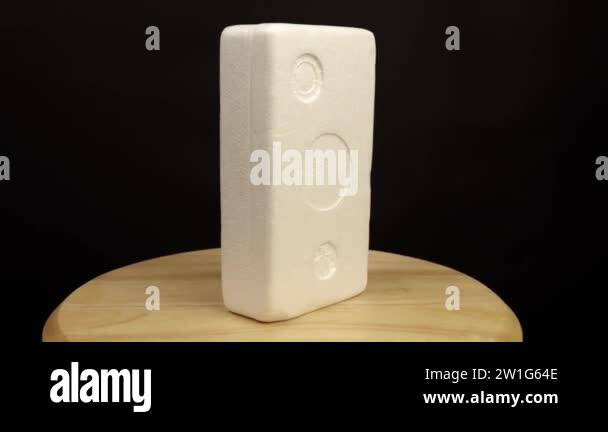 a piece of rectangular styrofoam lying vertically rotates 360 degrees ...