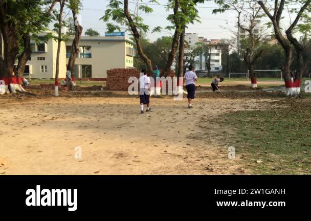 Young students playing cricket at the Dhaka Residential Model College in Mohammadpur, Dhaka, the ...