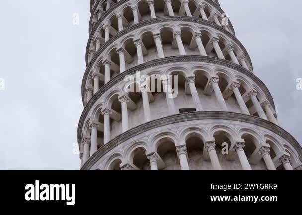The Leaning Tower of Pisa, Italy, famous for its tilt, with grey cloudy ...