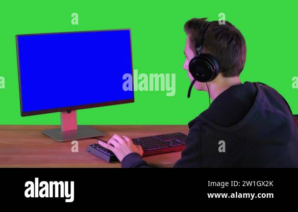 Excited Gamer with Headphones Smiling to the Camera on a Green Screen ...