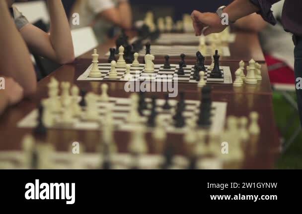 Man making move on chessboard during chess competition. Among large ...
