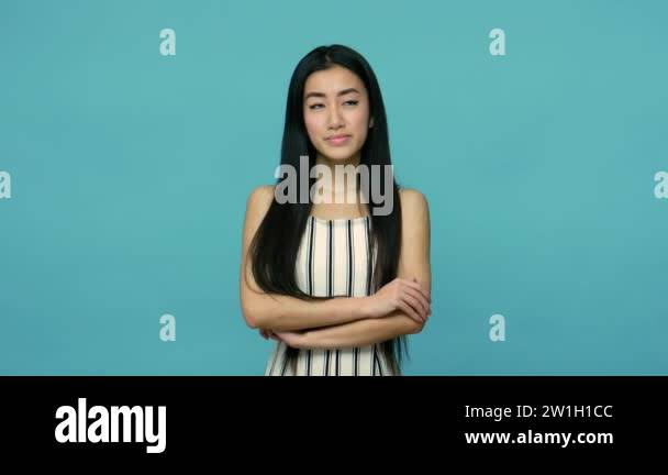 Confused thoughtful asian woman with long straight black hair in dress ...