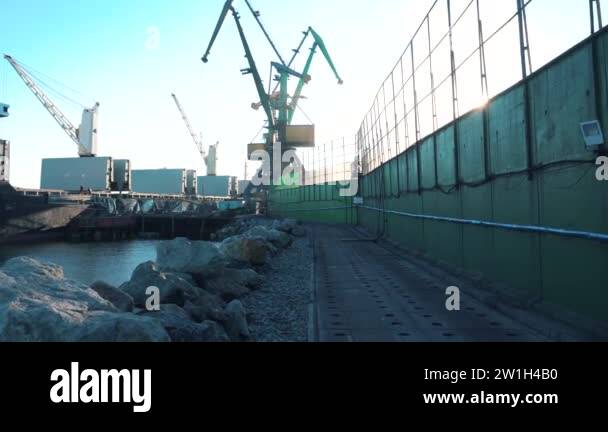 Mooring wall of the coal terminal. Coal loading on a cargo sea vessel ...