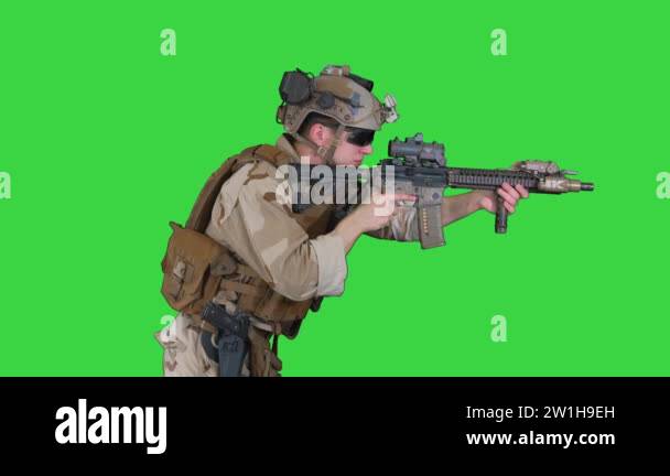 Marine aiming and shooting automatic rifle on a Green Screen, Chroma ...