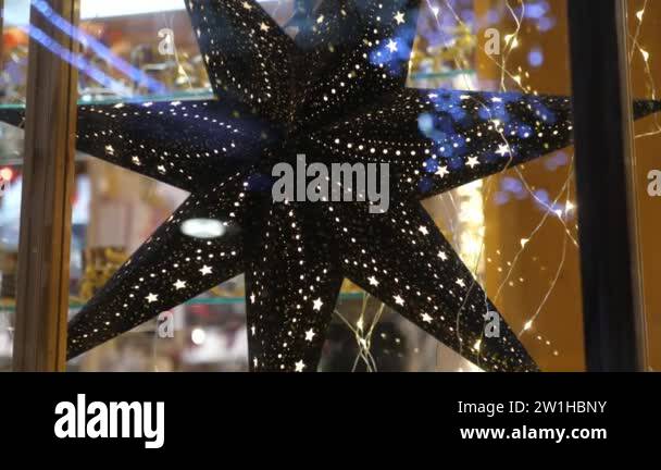 Large seven corner star in a shop window with New Year's souvenirs in ...