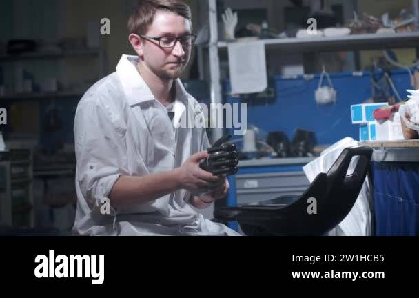 A scientist engineer is testing an electronic bionic prosthetic arm. He ...