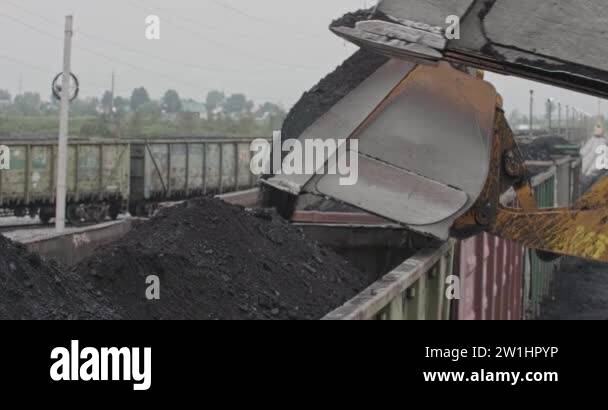 Slow motion loading of an loader into railway wagons. Excavator loading ...