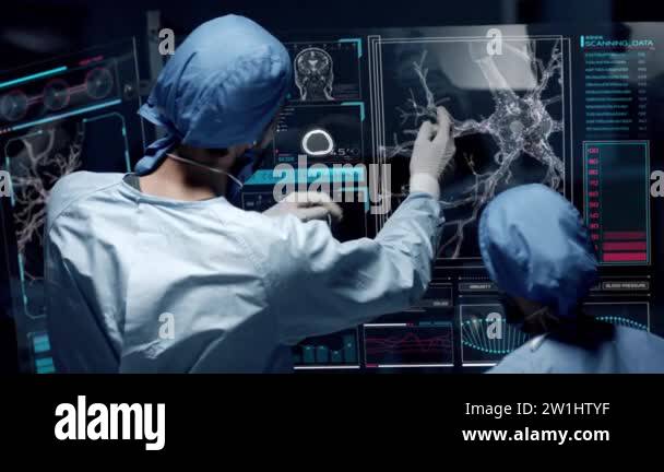 Professional doctors analyzing patient's medical MRI diagnosis by checking on a large glass ...