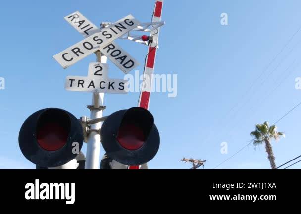 Level crossing warning signal in USA. Crossbuck notice and red traffic ...