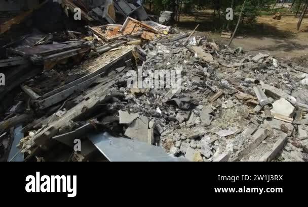 A vertical inspection of a half demolished building next to its ruined ...