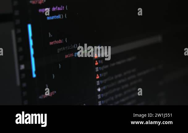 The programming work conducted on a large black pc screen with many ...