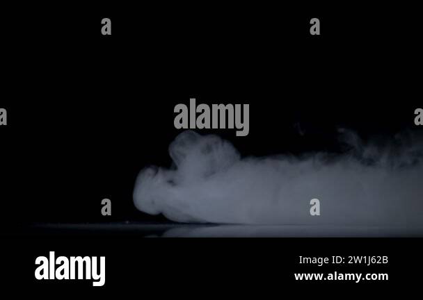 Abstract smoke cloud. White smoke slowly floating through space against ...